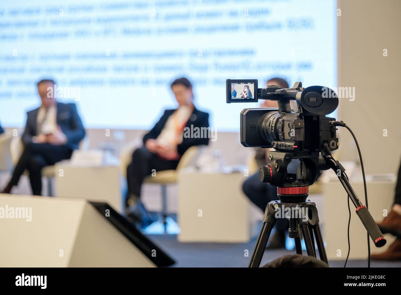 Camera shooting businesspeople on stage Stock Photo - Alamy