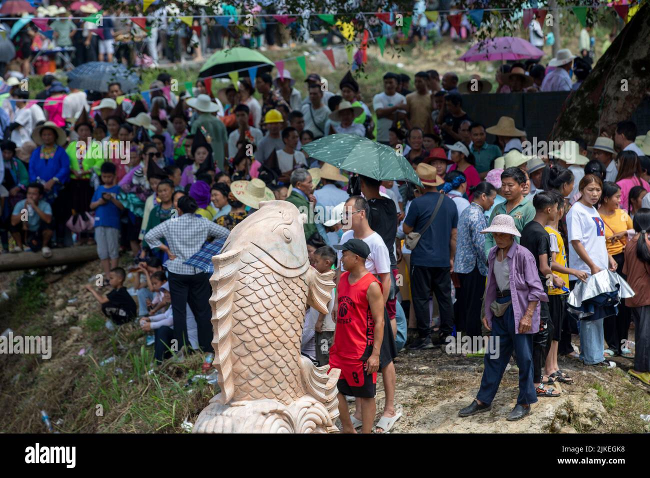 QIANDONGNAN, CHINA - AUGUST 1, 2022 - People take part in a fish festival activity in ...