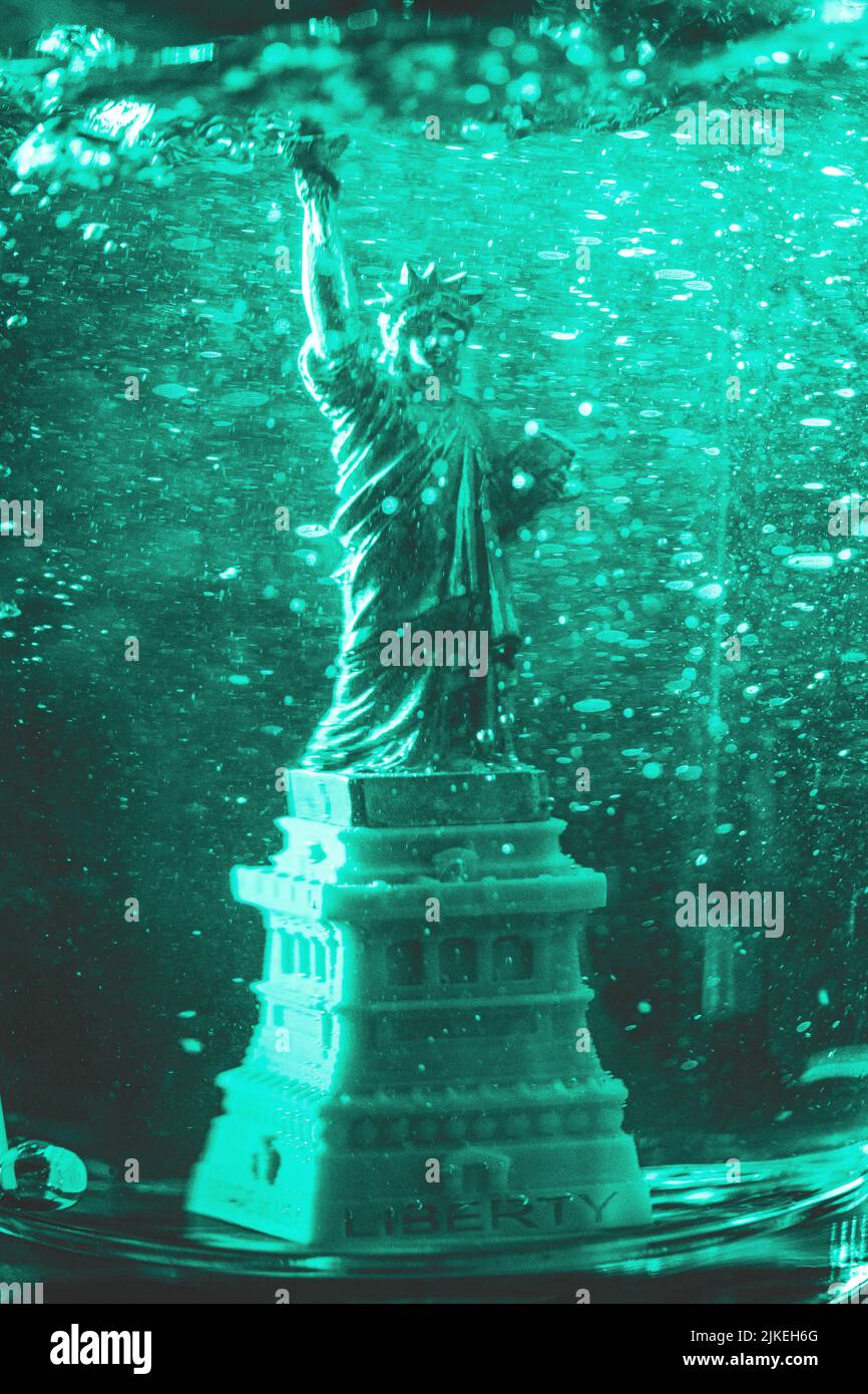 A vertical closeup shot of a small model of the Statue of Liberty in ...