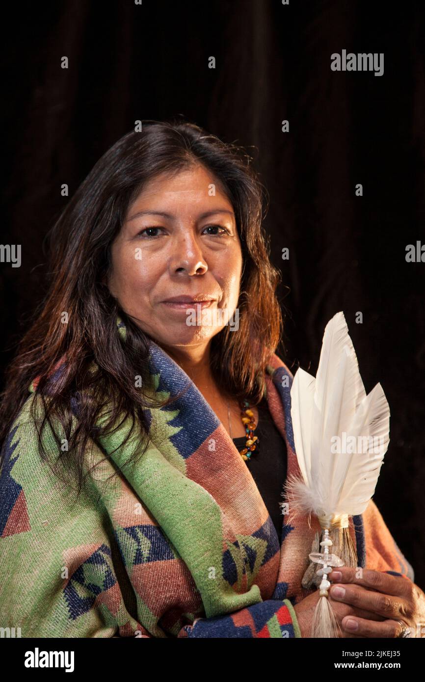 Native American medicine healer holds white feather smudging fan Stock ...