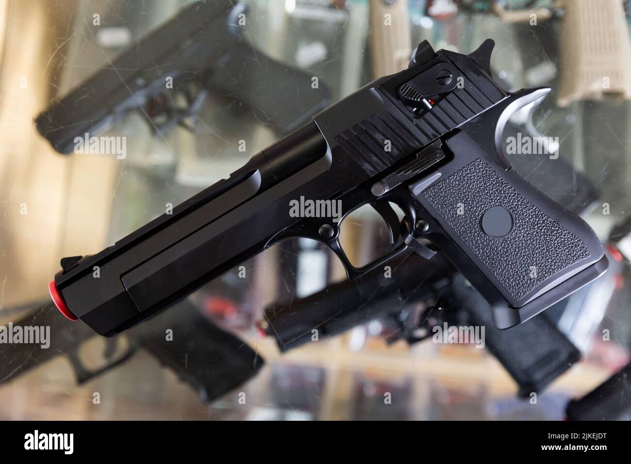 Replica of handgun on showcase Stock Photo - Alamy