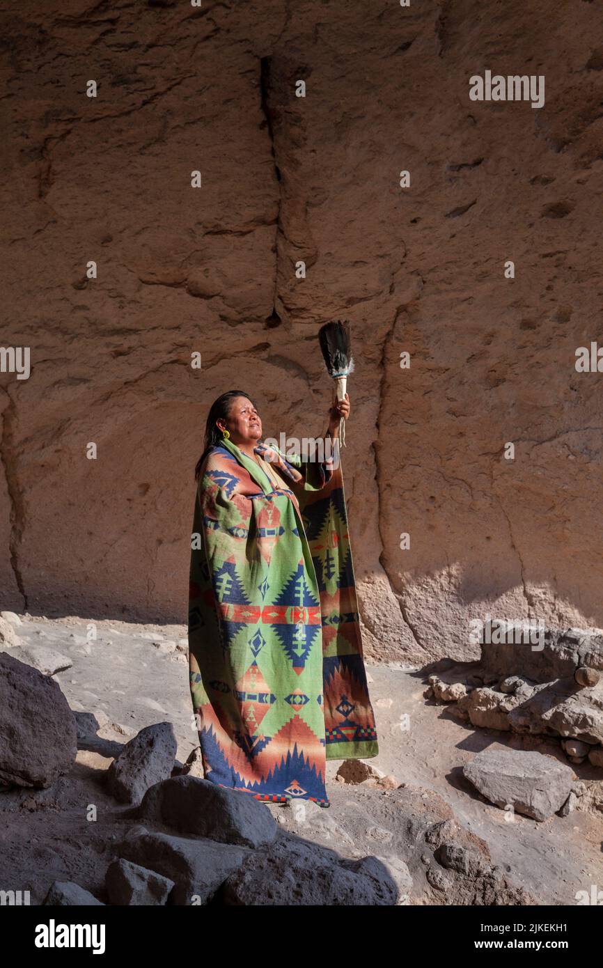 Woman of the Nakota Sioux Nation wears Native American blanket and gives a blessing inside a ...