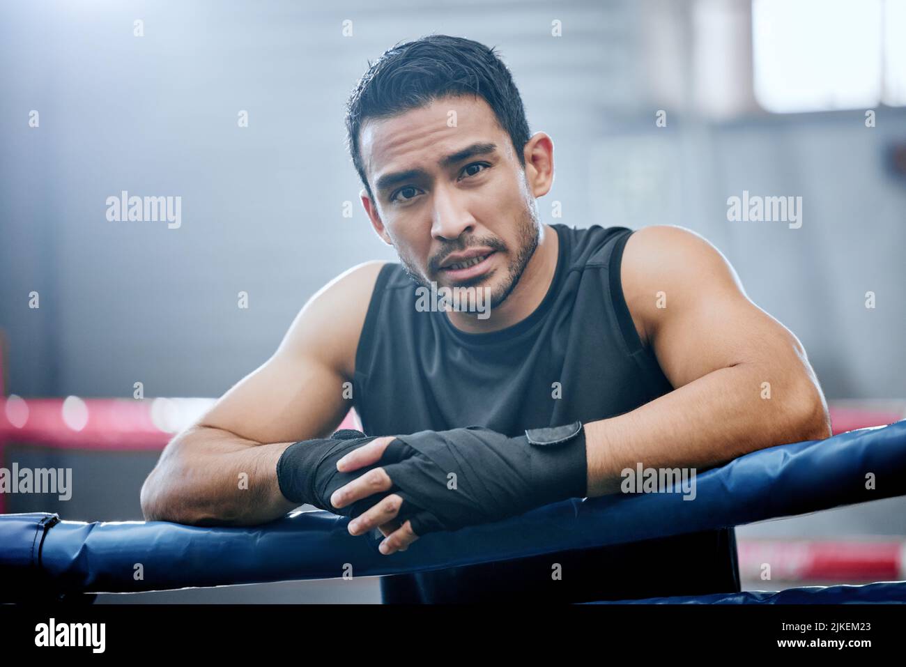 Young, fit and active man boxing, sweating and breathing heavily after ...