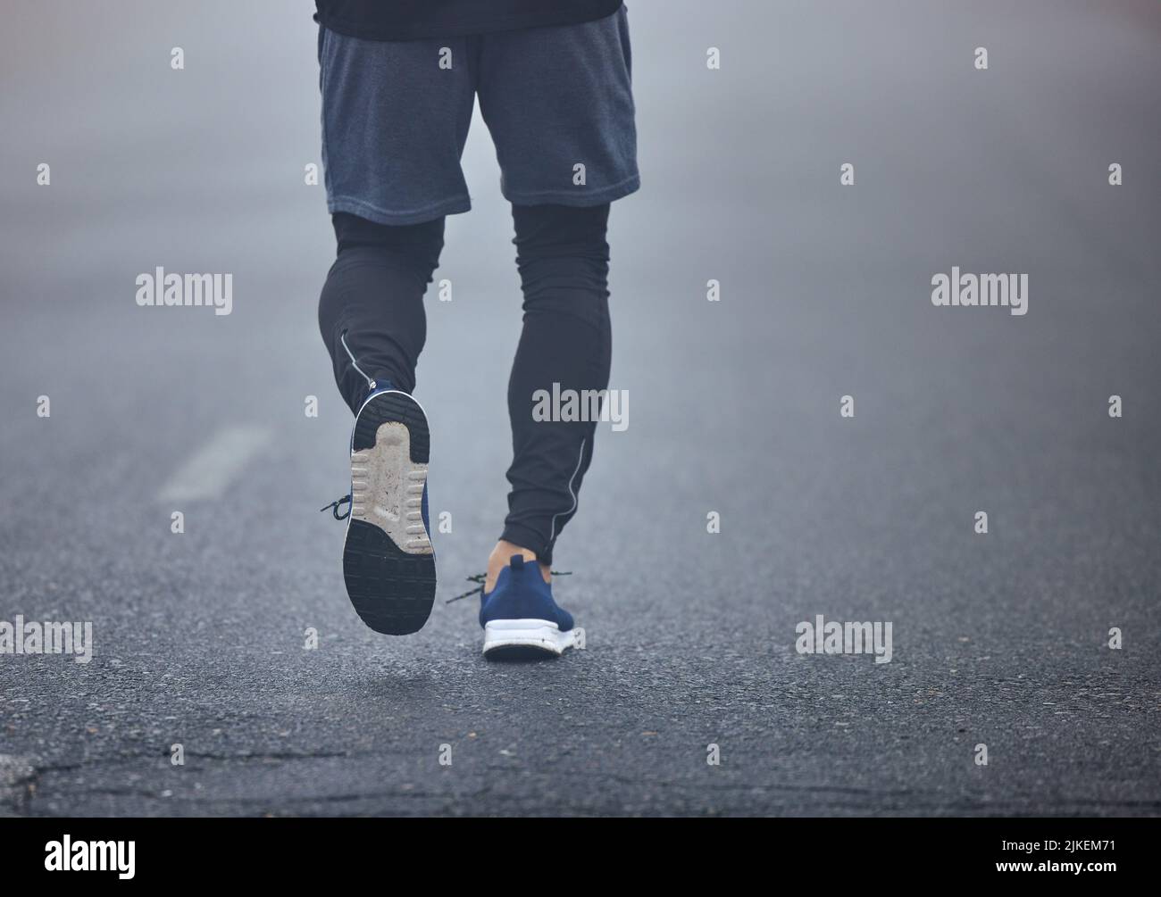 Run to the finish line. Rearview shot of an unrecognisable man running ...