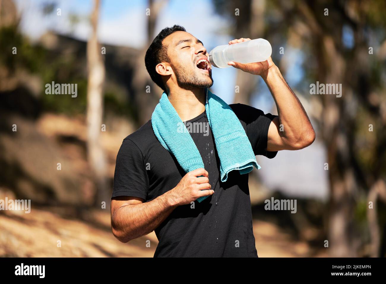 Exercising is the best part of my day. a man drinking water while out ...