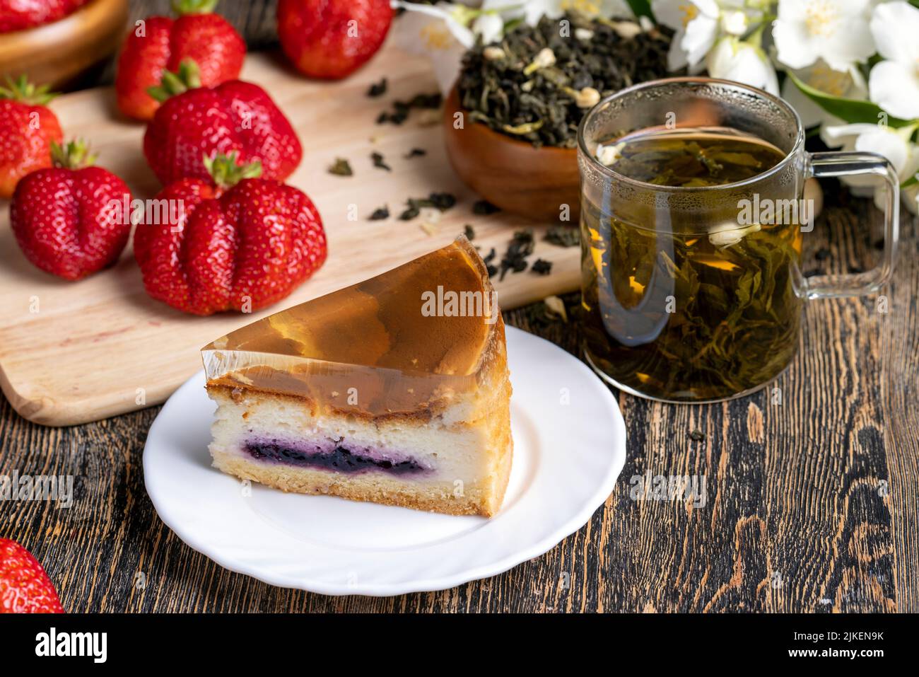 Brewed green tea with jasmine on the table, dried tea leaf for brewing ...