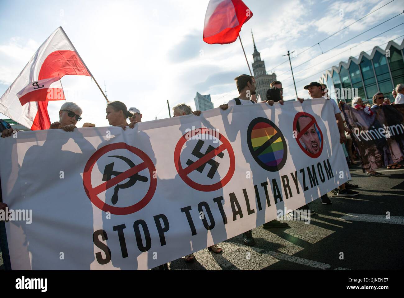 People hold a banner with symbols crossed out during the march in ...