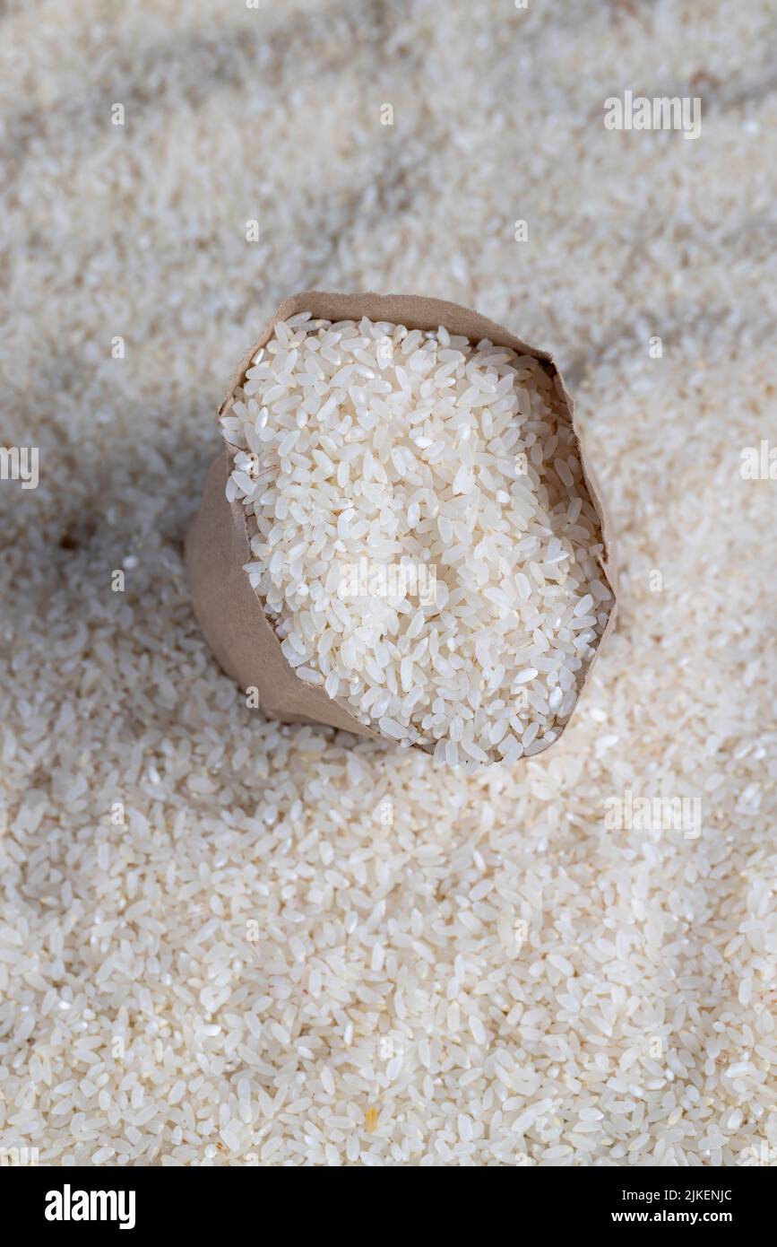 a pile of white rice on the kitchen table in a bag, white uncooked rice ...