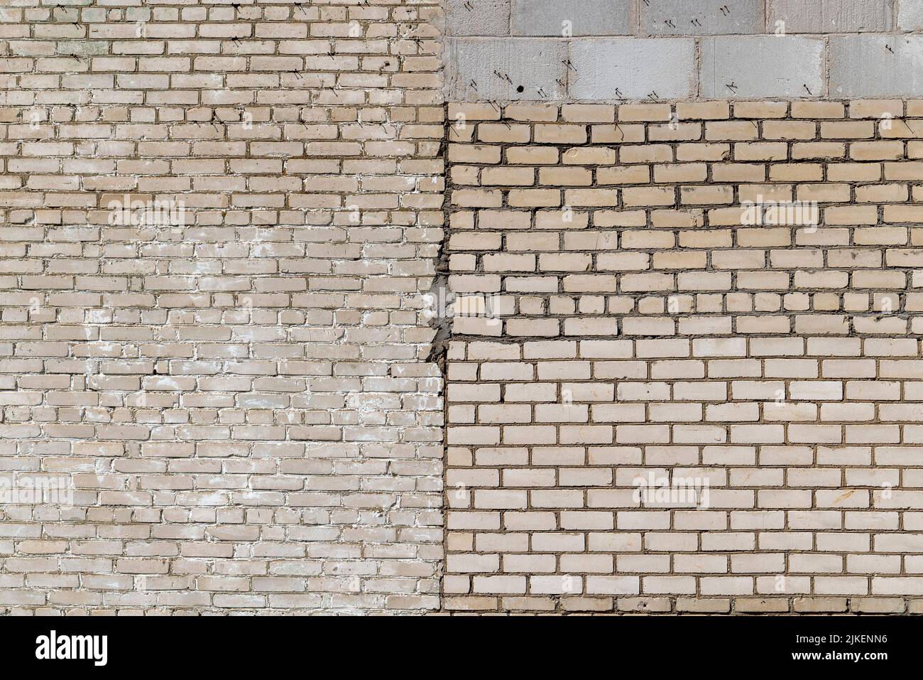 an old brick wall made of a large number of different types of bricks ...