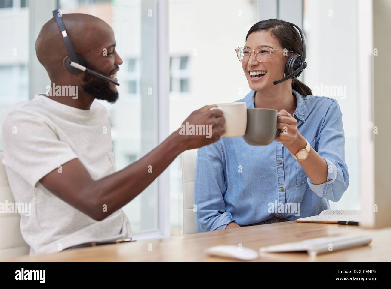 Cheers to a beautiful day. two colleagues enjoying their coffee ...