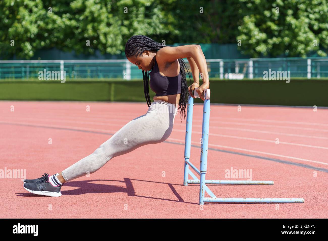 African American sportswoman enjoys pumping up legs and body using ...