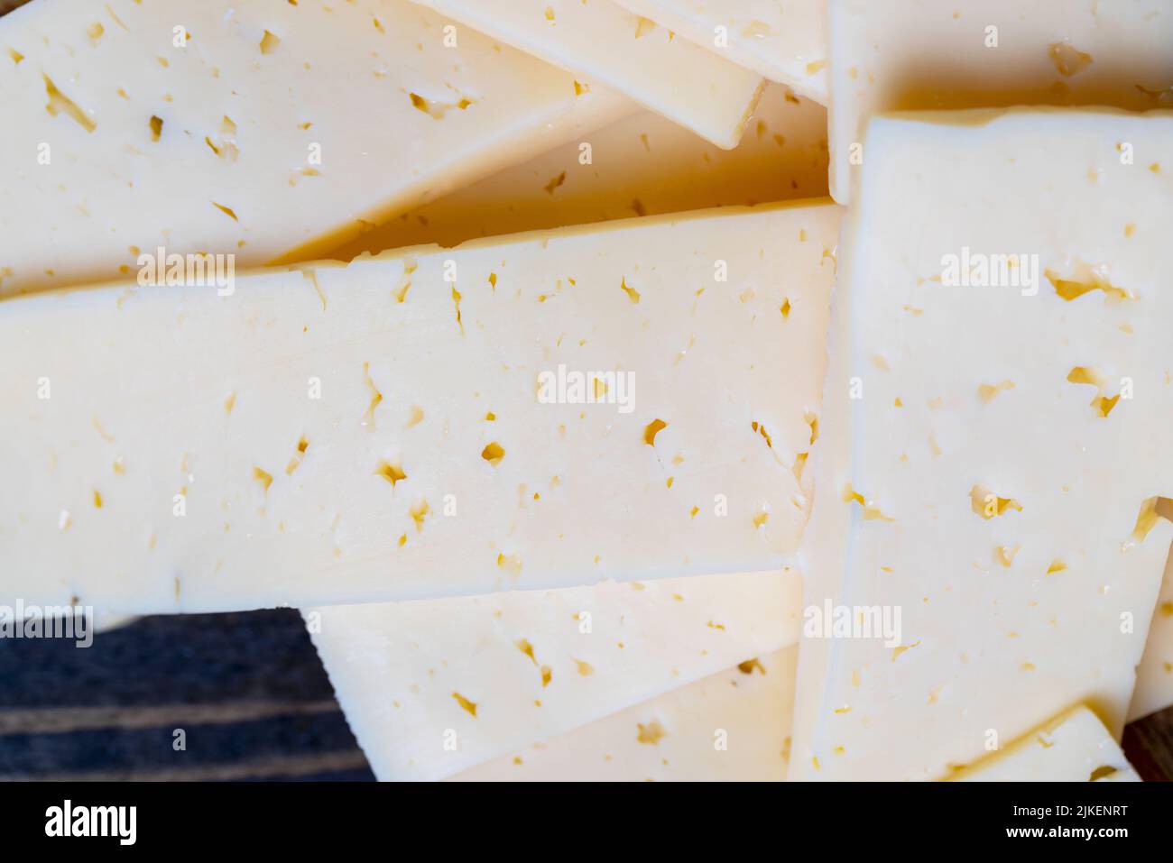 cut into pieces real hard cheese with lots of milk, the product of milk ...