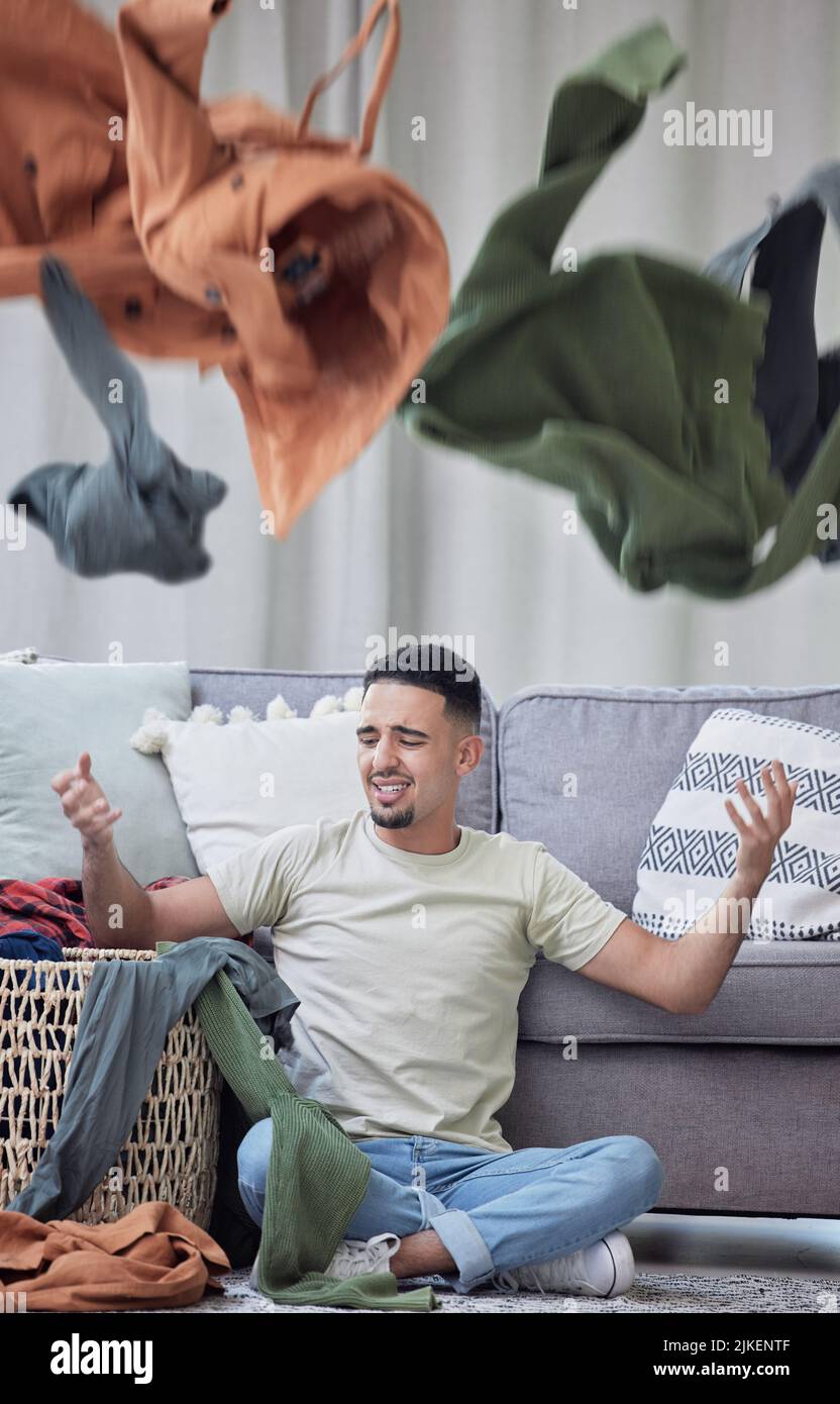 Laundry is a like a never ending story. a young man doing laundry at ...