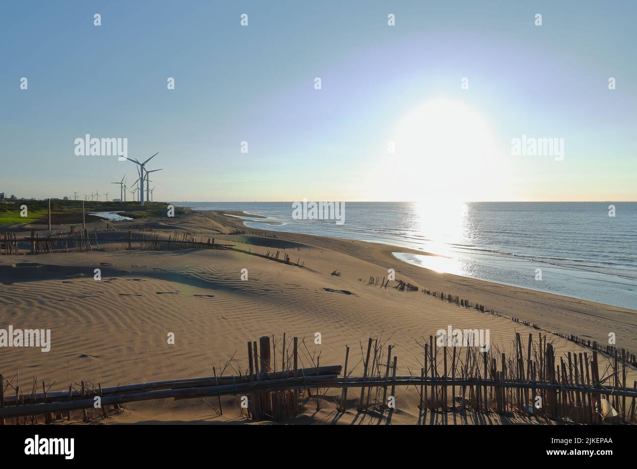Beautiful sand dune and windmill at the beach in Dayuan District ...