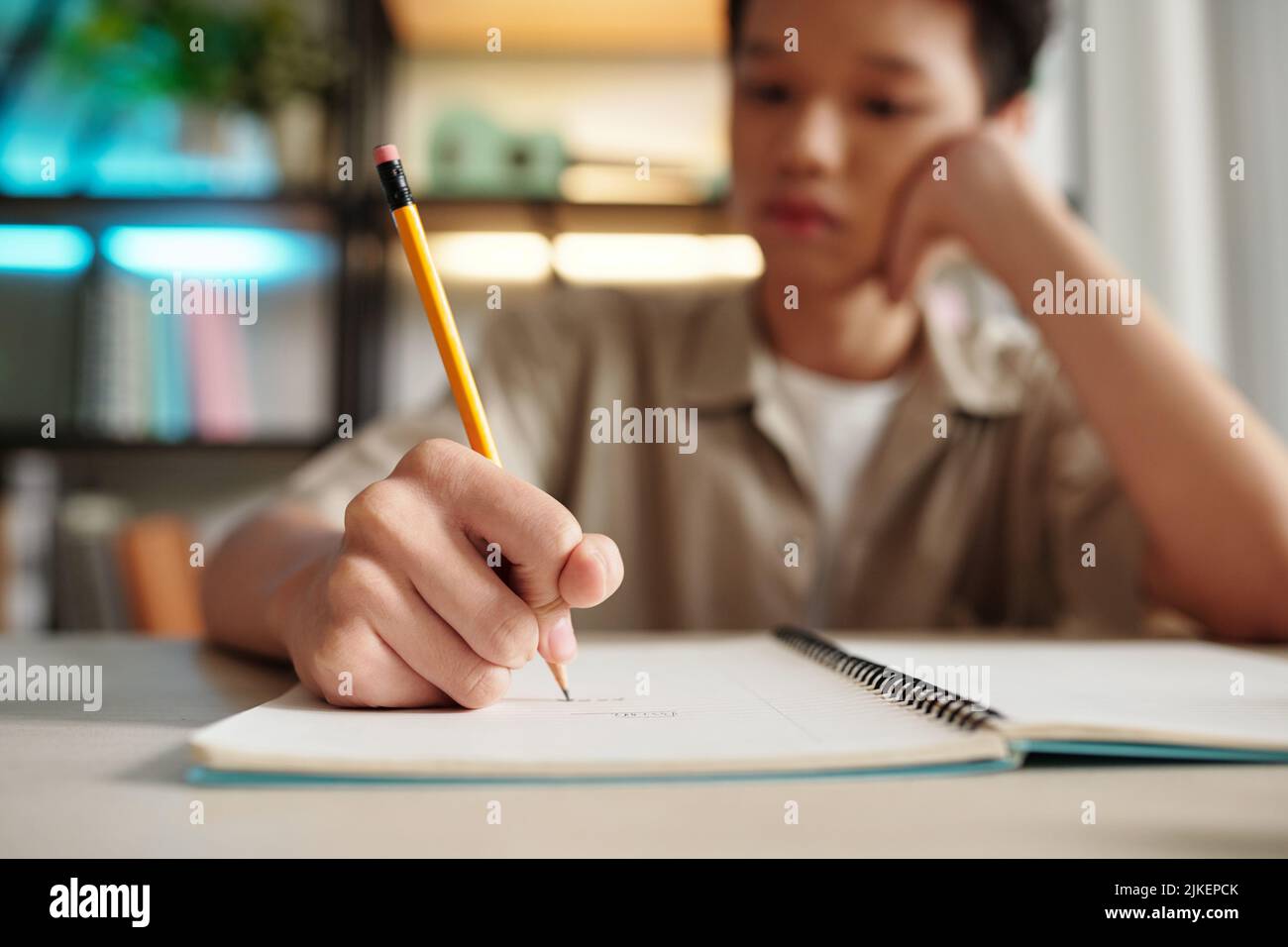 Schoolboy has no inspiration for essay he needs to white in class Stock ...