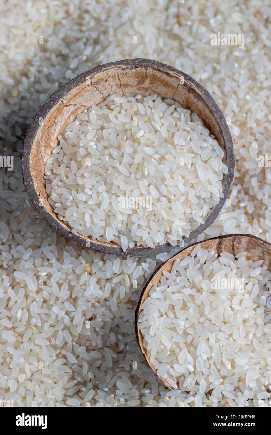 a pile of white rice on the kitchen table in a wooden plate made of ...