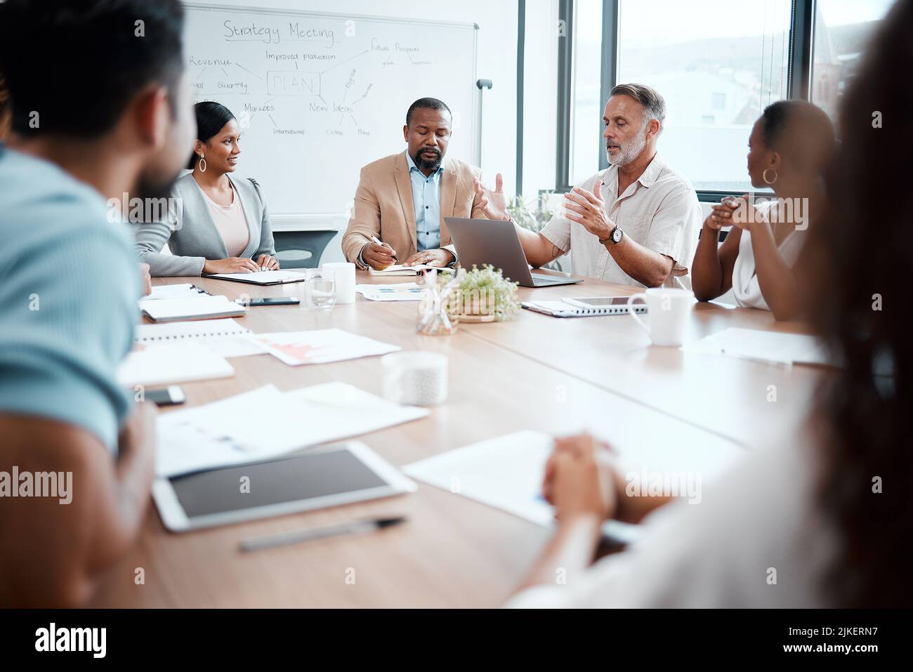 As youll see here. a group of staff listening to their boss during a ...