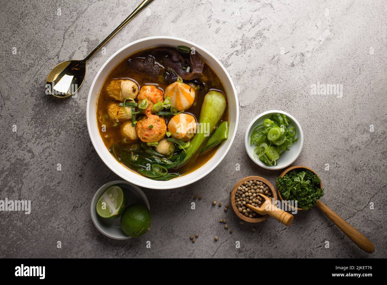 Tom Yam Spicy Thai soup with fish meatball, seafood, coconut milk ...