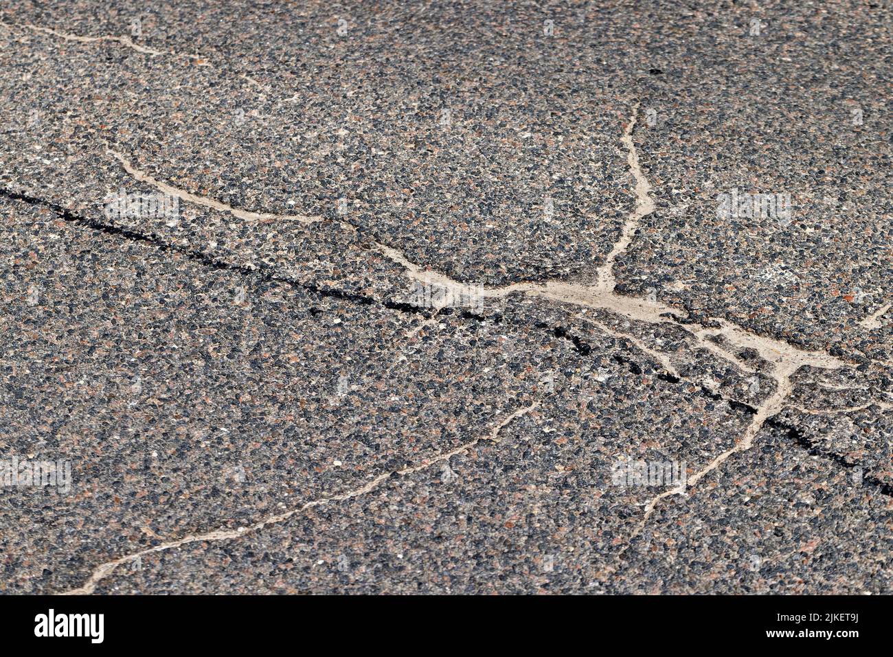 poor paved road with a lot of holes and potholes, poor transport ...