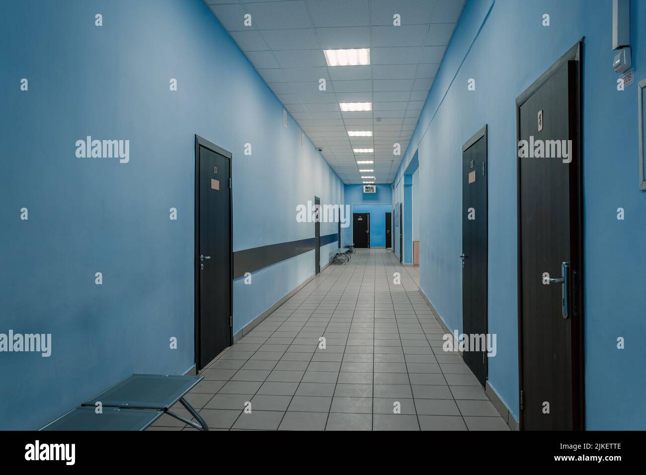 School corridor, hallway of college or university. Light yellow walls ...