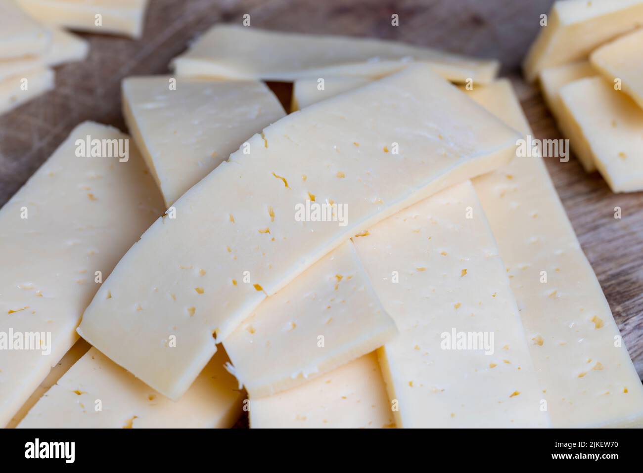 cut into pieces real hard cheese with lots of milk, the product of milk ...