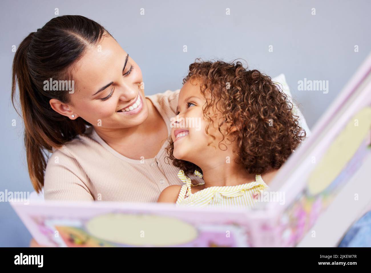 Youre my best girl. a mother reading her daughter her favourite story ...