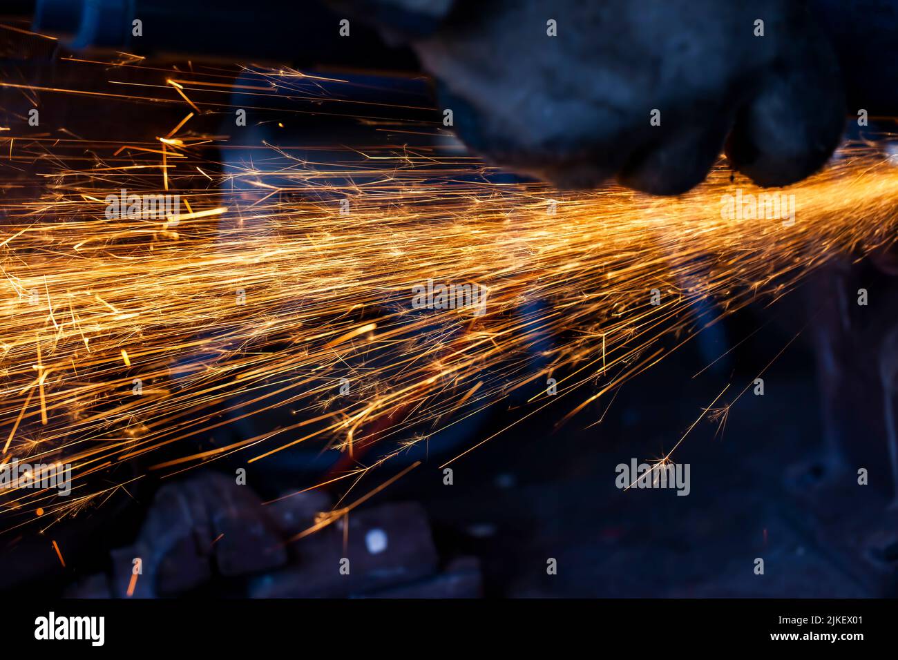 Orange sparks during metal surface treatment, construction work with ...