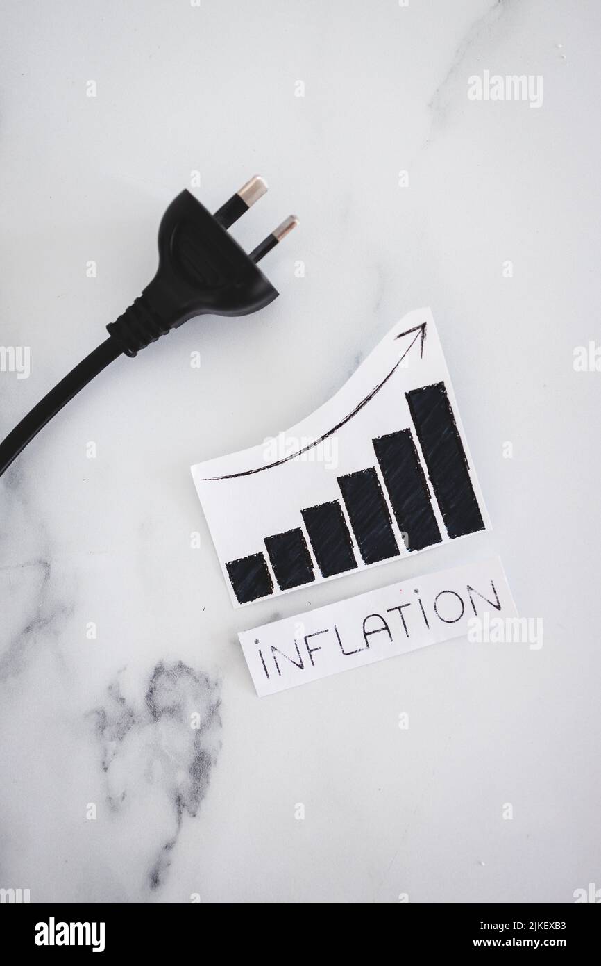 electricity costs going up ,conceptual image with plug nxt to stats ...