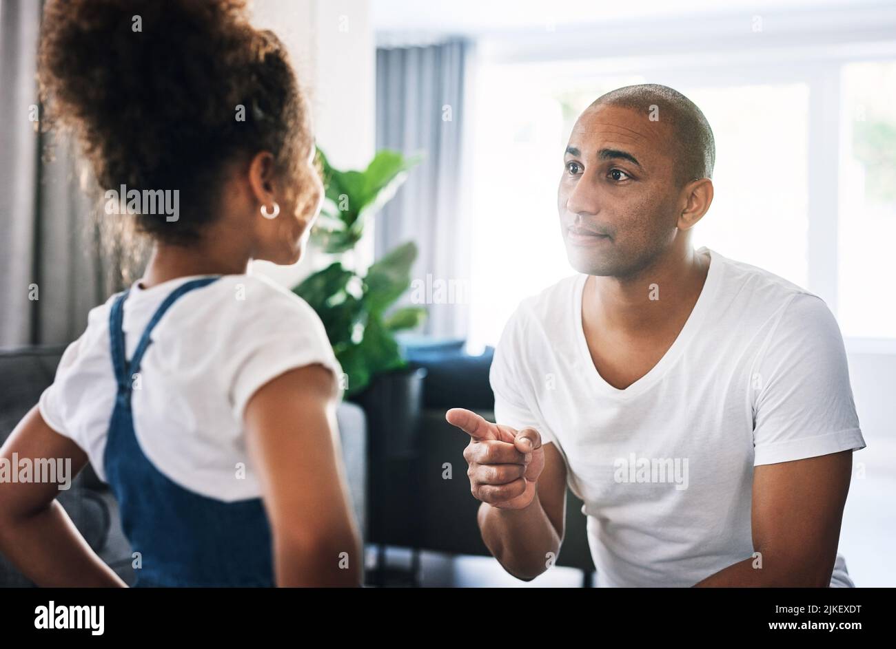 Dont smile when Im scolding you. a young father reprimanding a child at ...