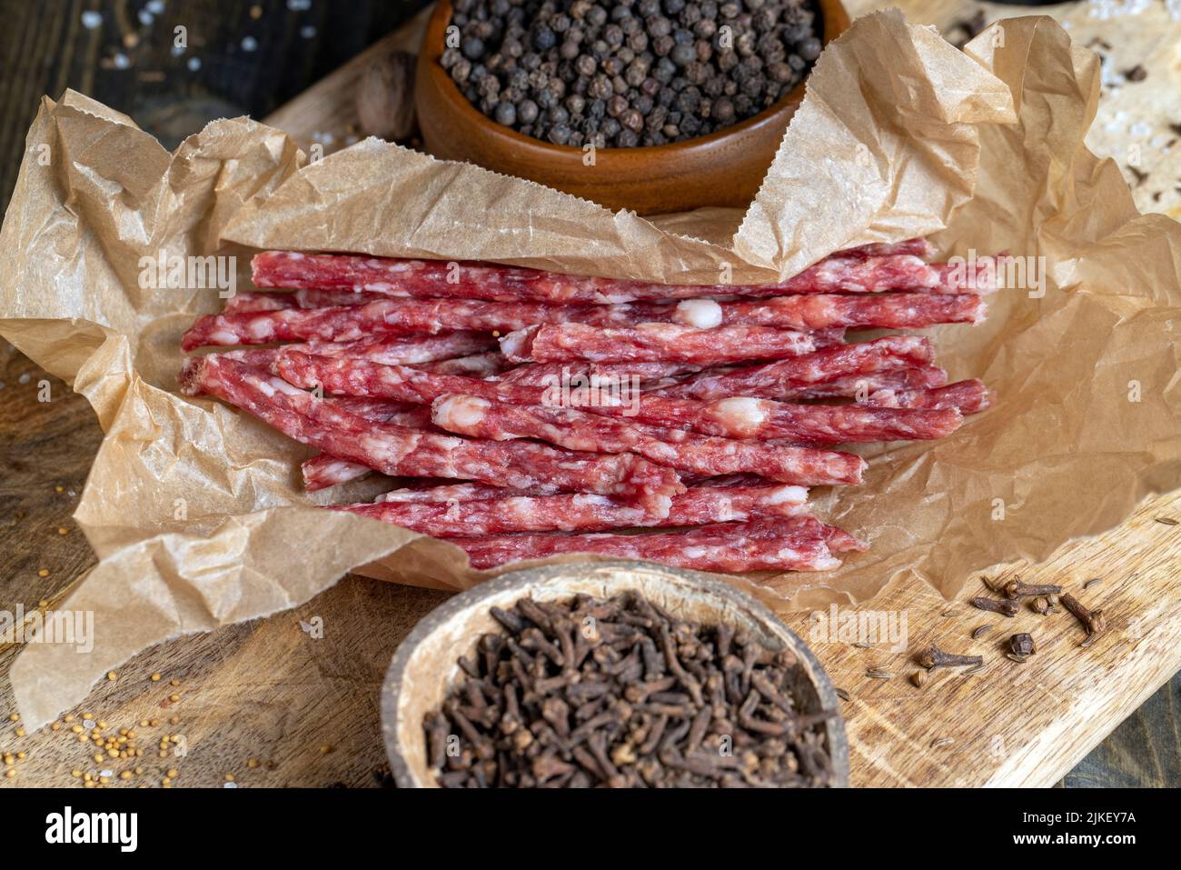 thin dried meat sausages with spices , dried pork meat food while ...