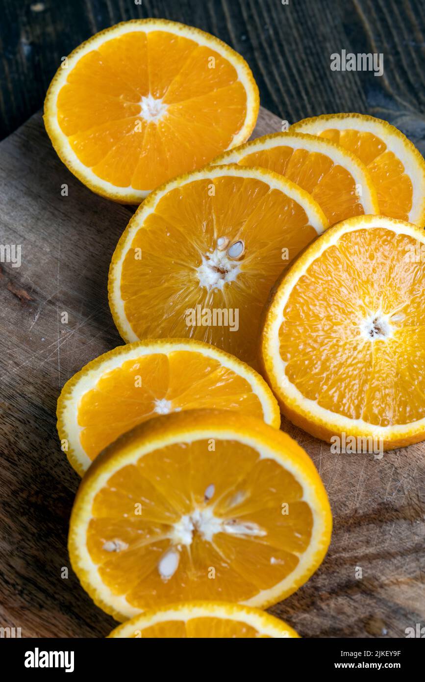 not peeled ripe orange cut into slices during cooking, ripe orange ...