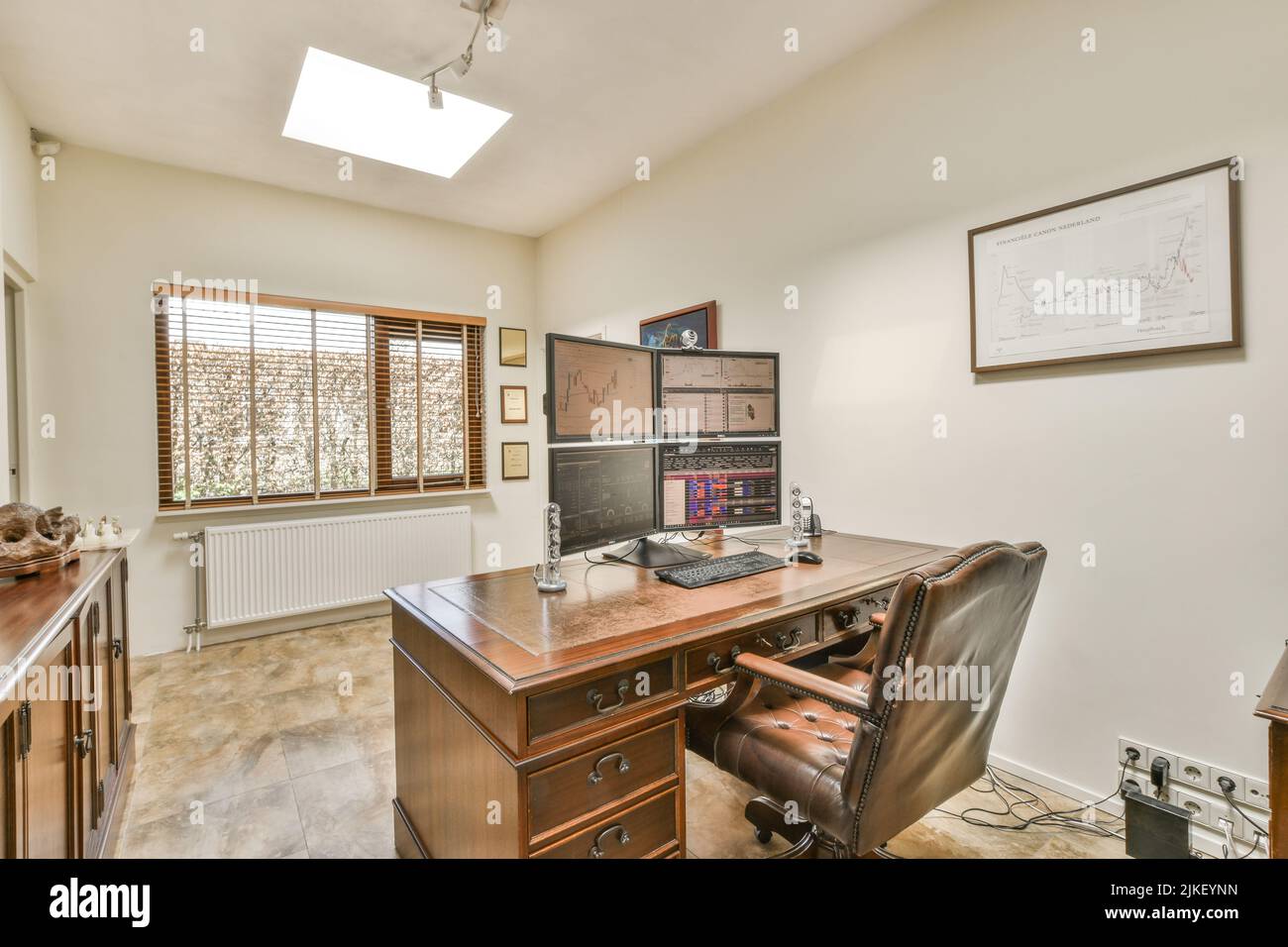 Comfortable chair placed near desk with computer monitors and ...