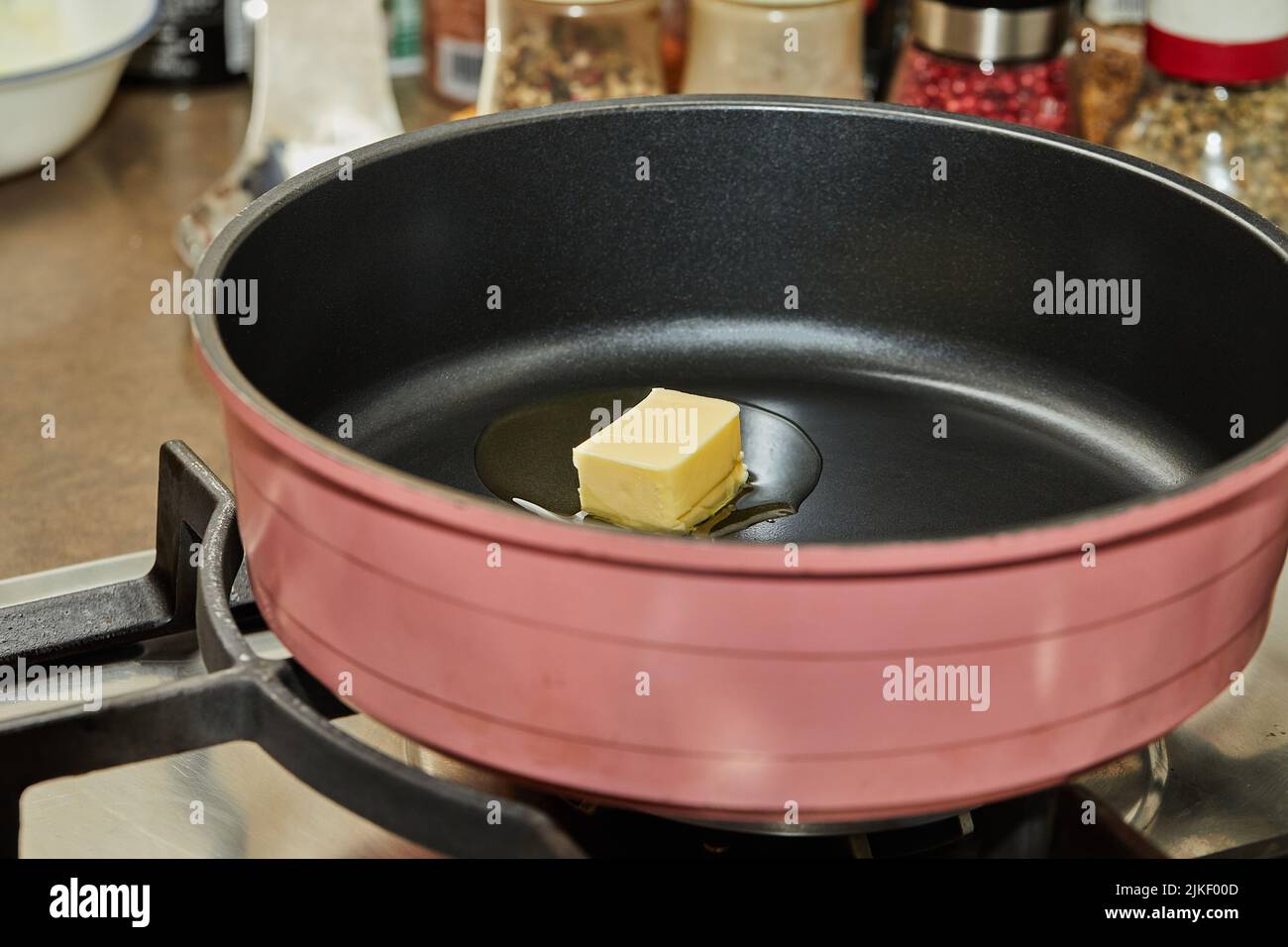 Piece of butter is melted in pan before cooking Stock Photo - Alamy