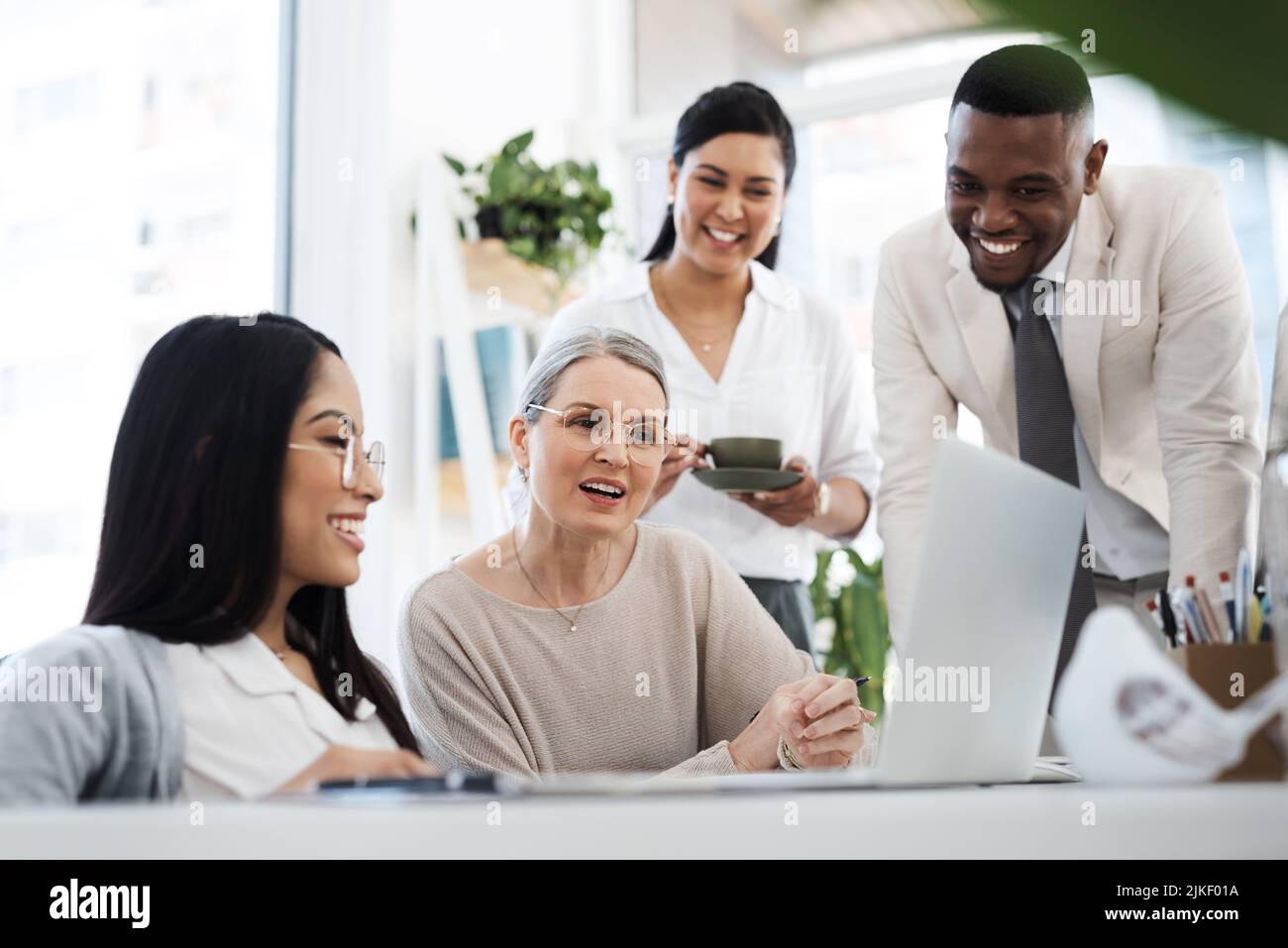 Gathered around to discuss ideas. a group of diverse businesspeople ...