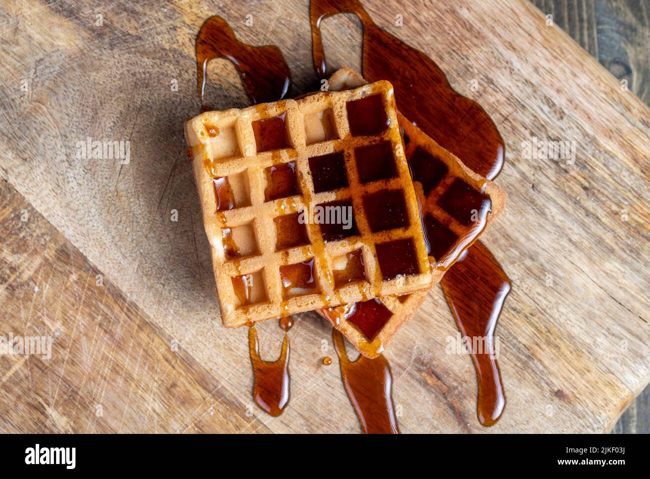 square sweet soft waffles in bee honey , a traditional European dessert ...