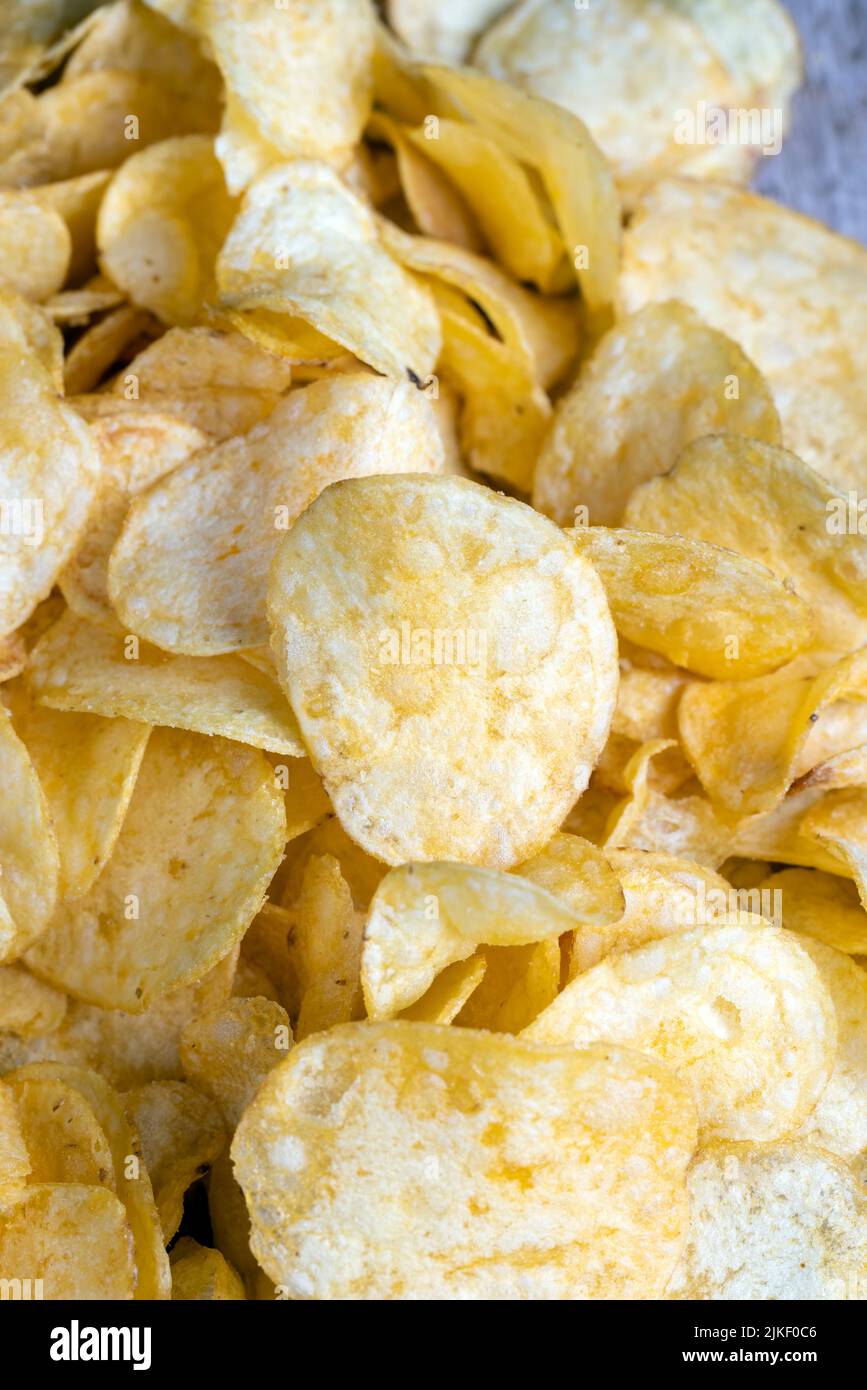 scattered potato chips with natural spices , fried potato chips with ...