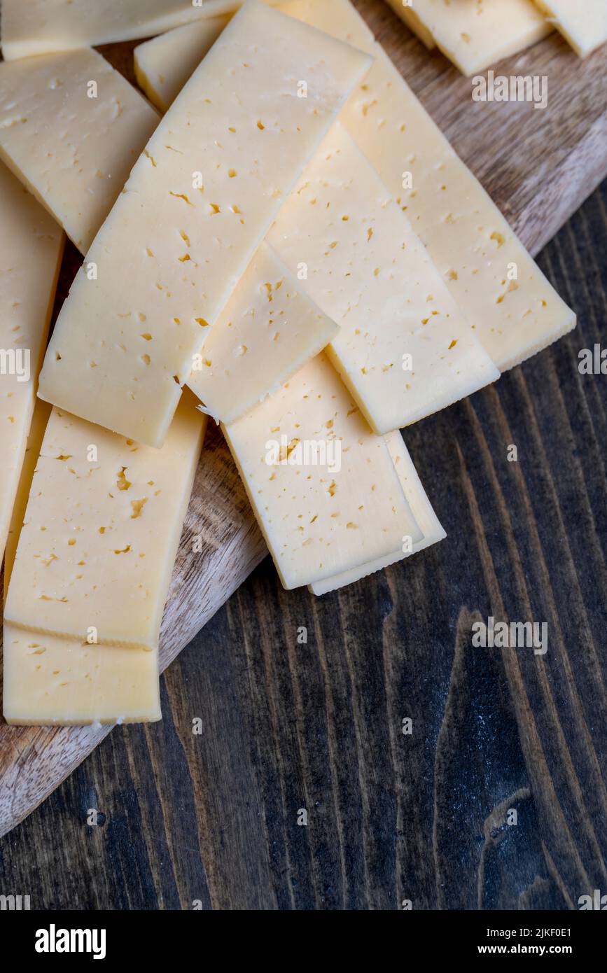 cut into pieces real hard cheese with lots of milk, the product of milk ...