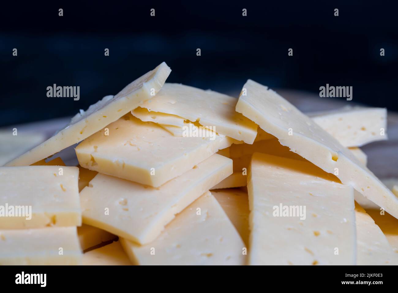 cut into pieces real hard cheese with lots of milk, the product of milk ...