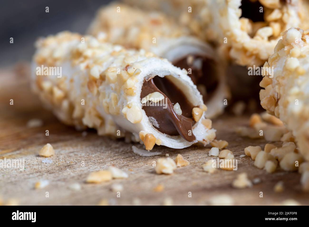 waffle tube with chocolate filling and crushed peanuts, sweet waffle ...
