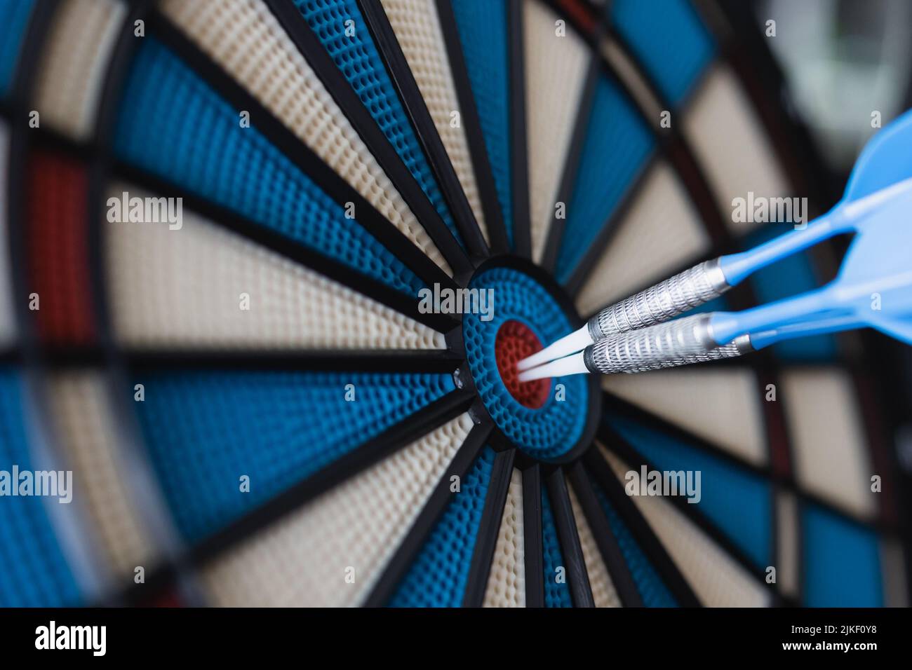 A dart hitting the center of target with copy space in dramatic light ...