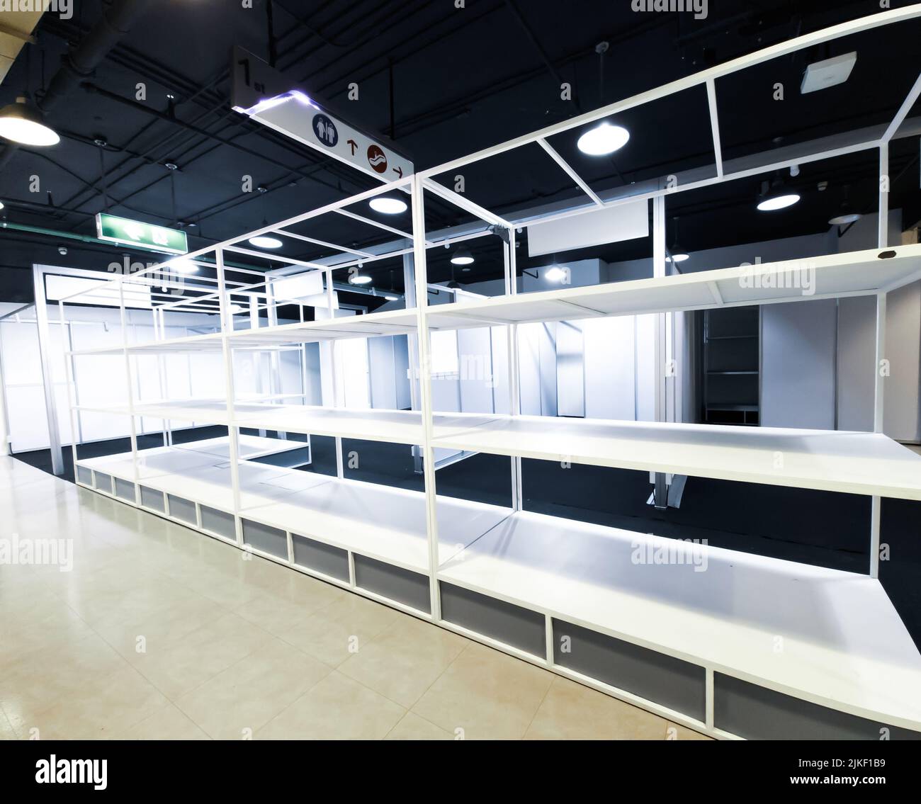 Trade show interior with empty booth and shelves inside the business ...