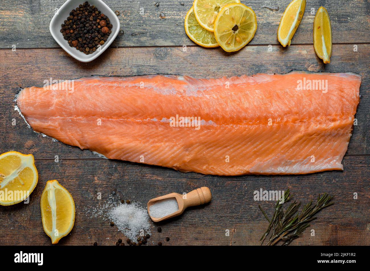 Raw salmon fillets with lemon, salt, pepper. Chilled salmon fillet on ...