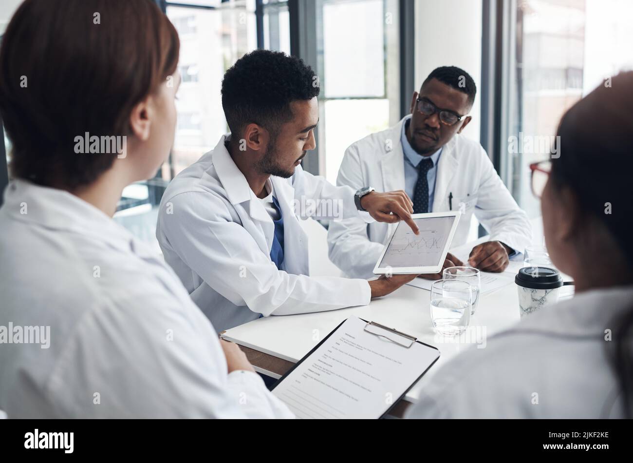 Thank you for meeting me on short notice. a group of doctors having a ...