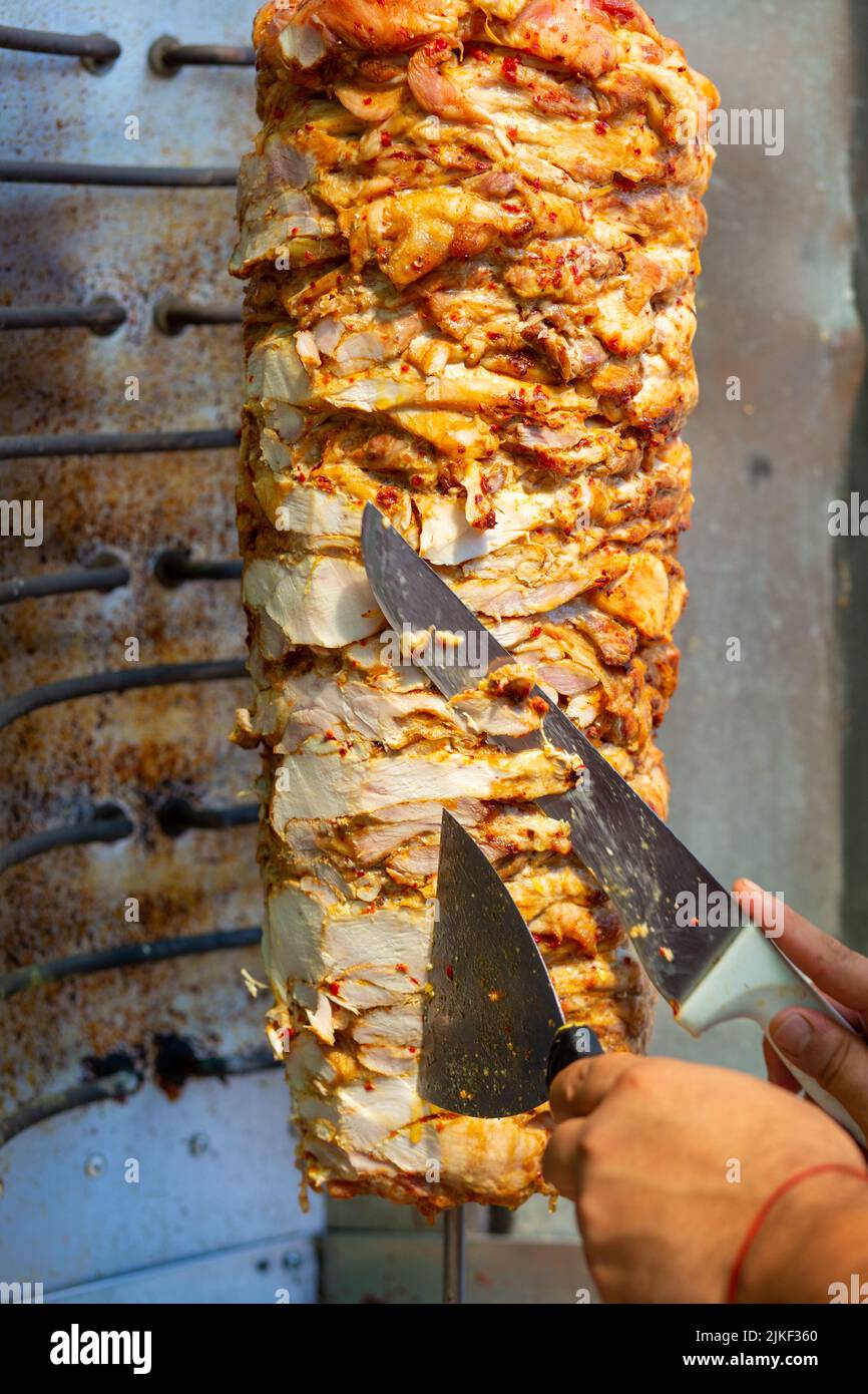 Chef cutting with doner knife Traditional Turkish Doner Kebab meat ...