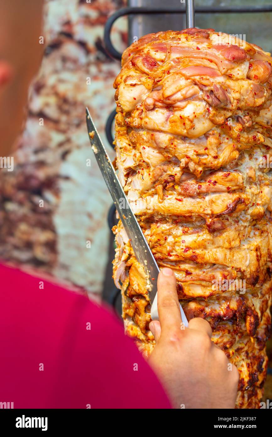 Chef cutting with doner knife Traditional Turkish Doner Kebab meat ...