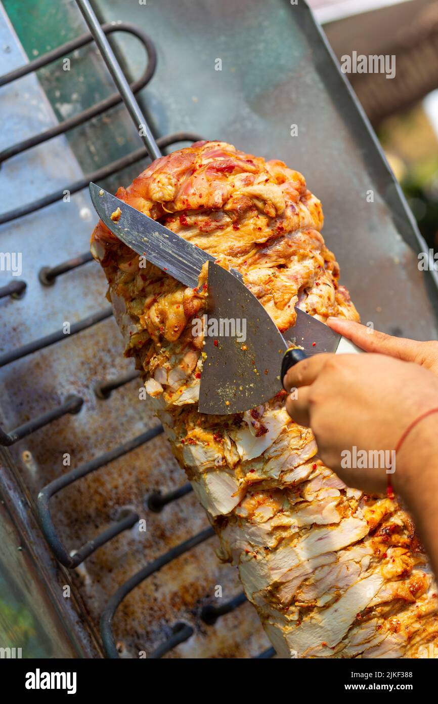 Chef cutting with doner knife Traditional Turkish Doner Kebab meat ...