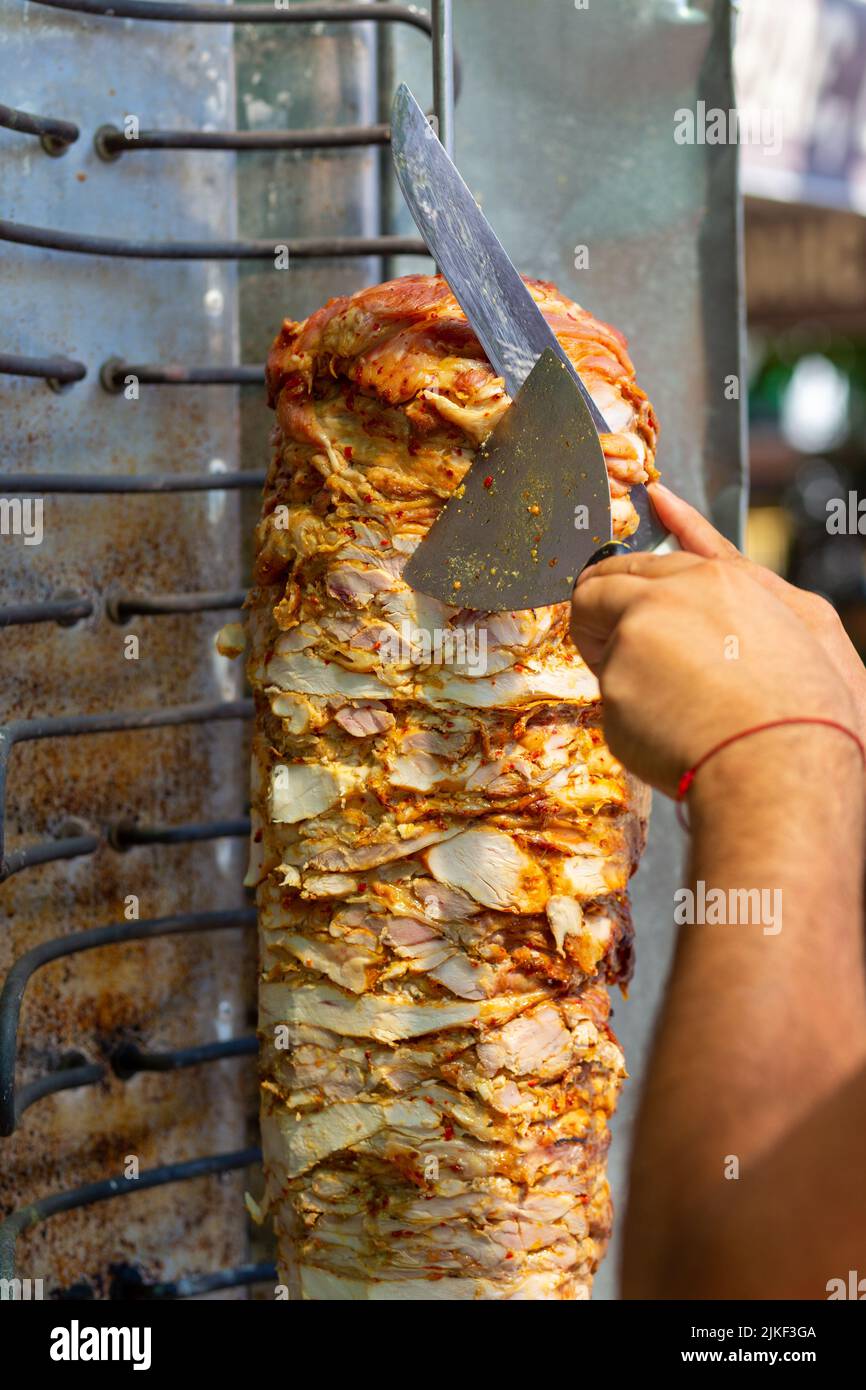 Chef cutting with doner knife Traditional Turkish Doner Kebab meat ...