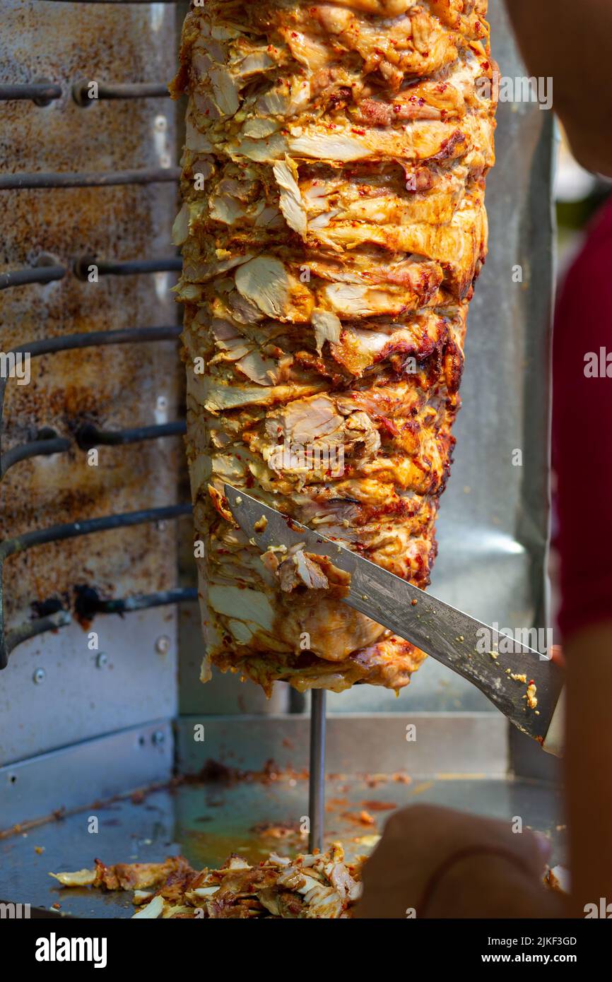 Chef cutting with doner knife Traditional Turkish Doner Kebab meat ...