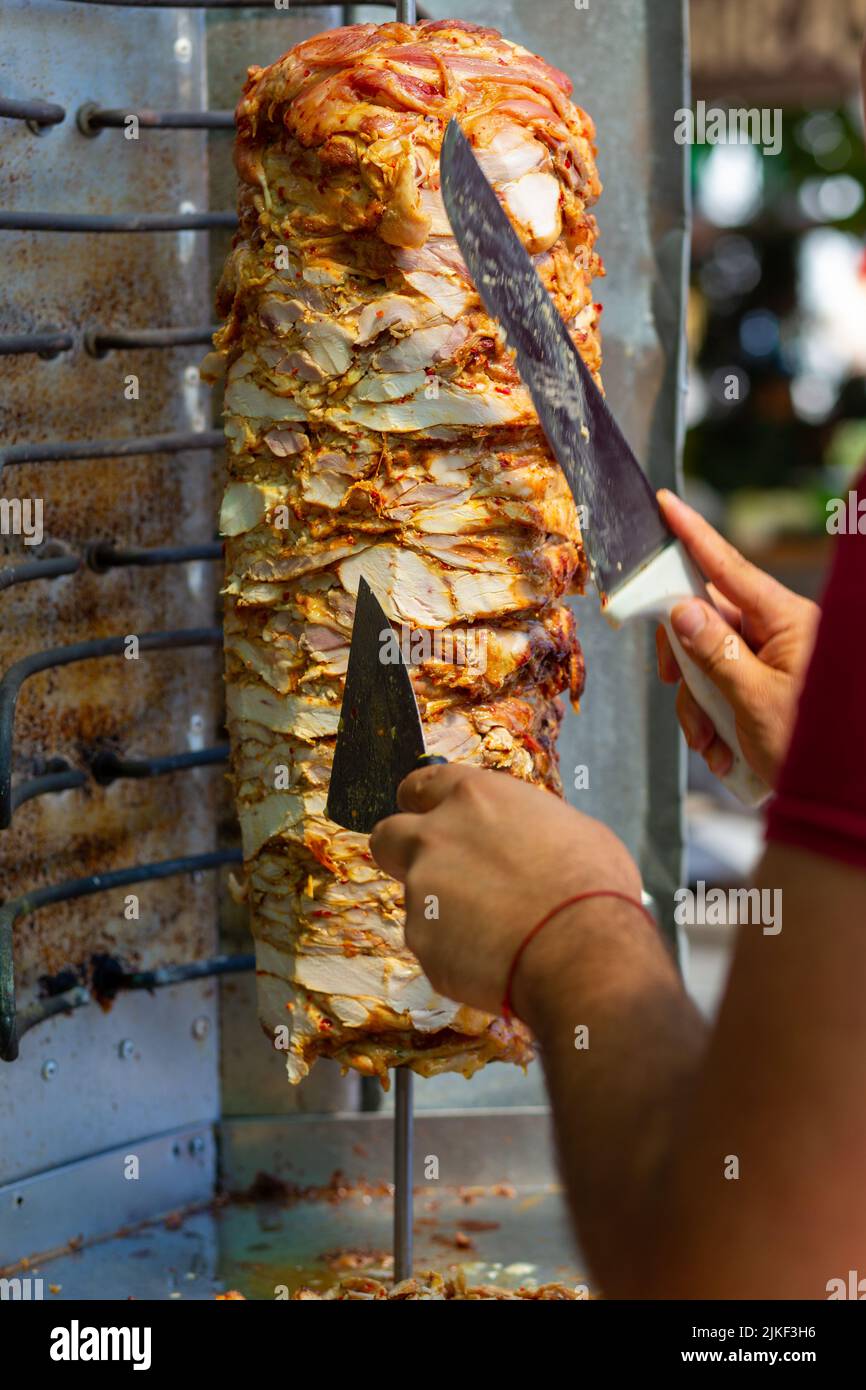 Chef cutting with doner knife Traditional Turkish Doner Kebab meat ...