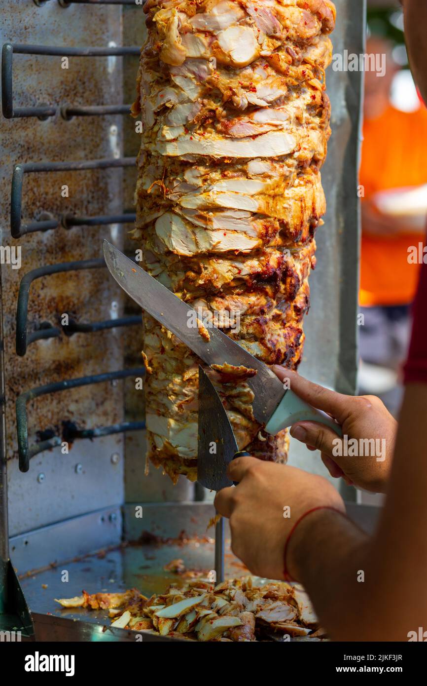 Chef cutting with doner knife Traditional Turkish Doner Kebab meat ...
